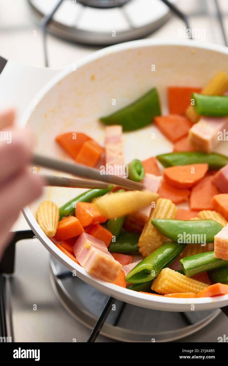 Woman frying bacon hi-res stock photography and images - Alamy