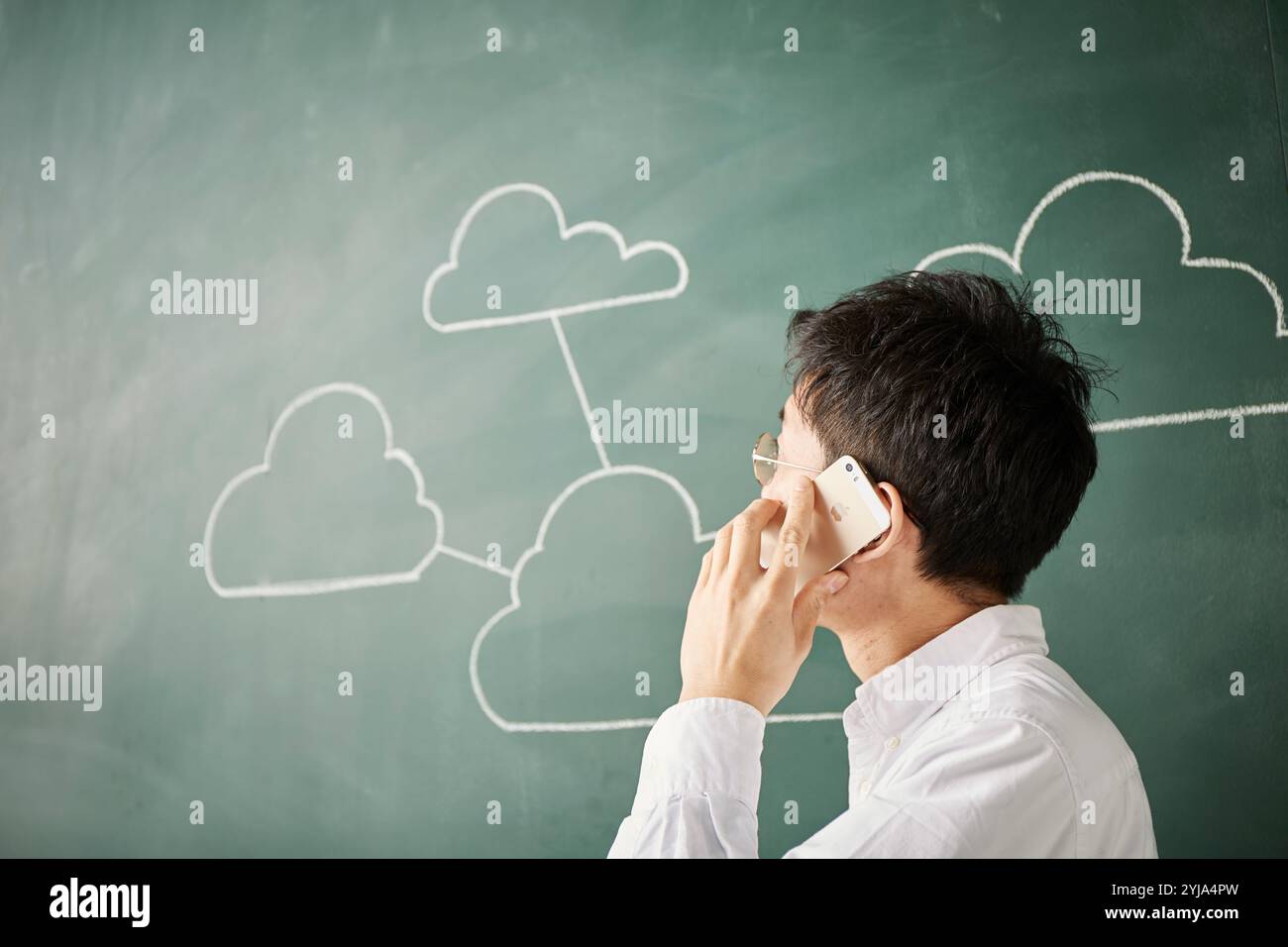 A person making a phone call in front of several connected clouds ...