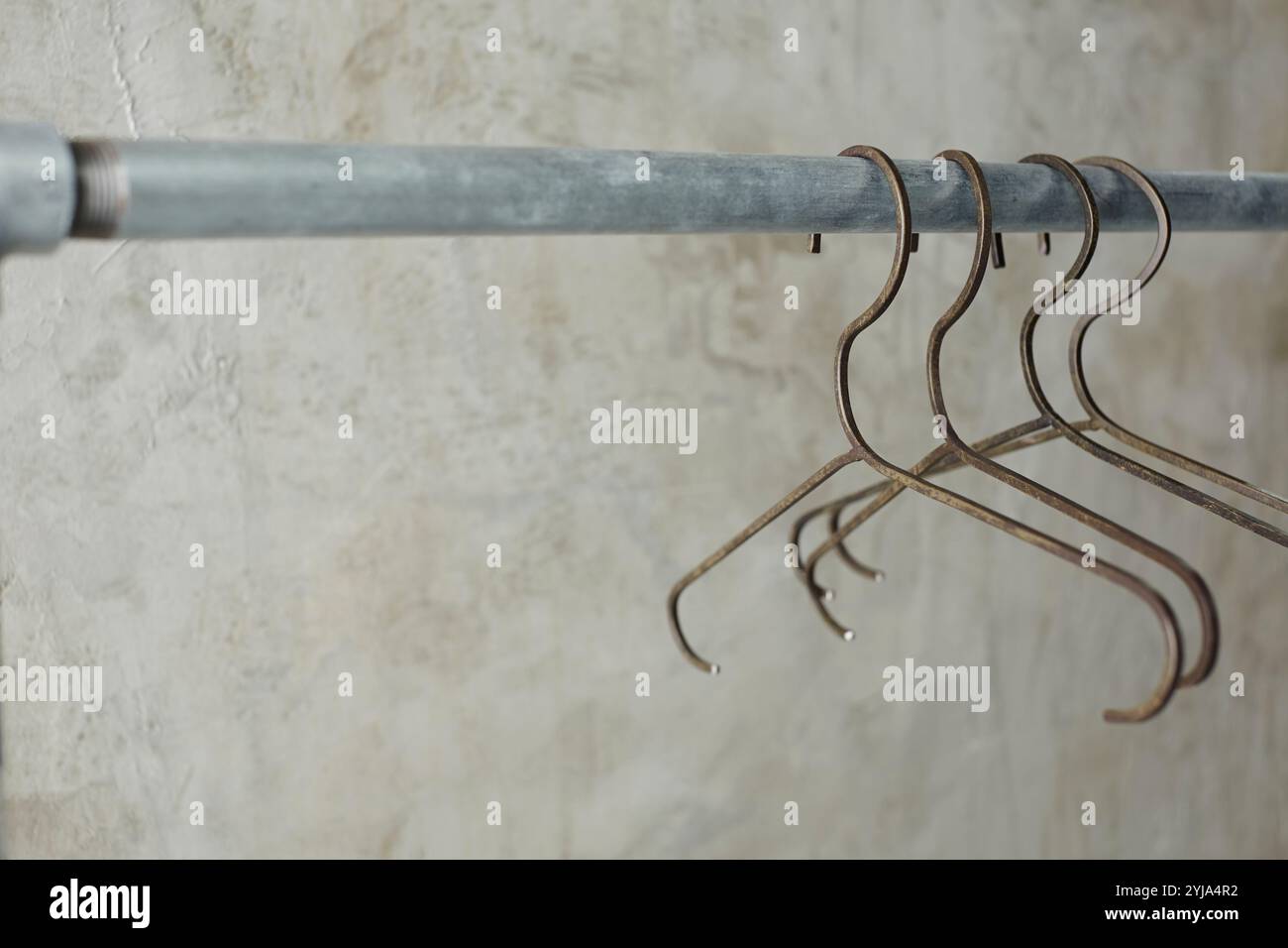 Hangers on silver rack Stock Photo - Alamy