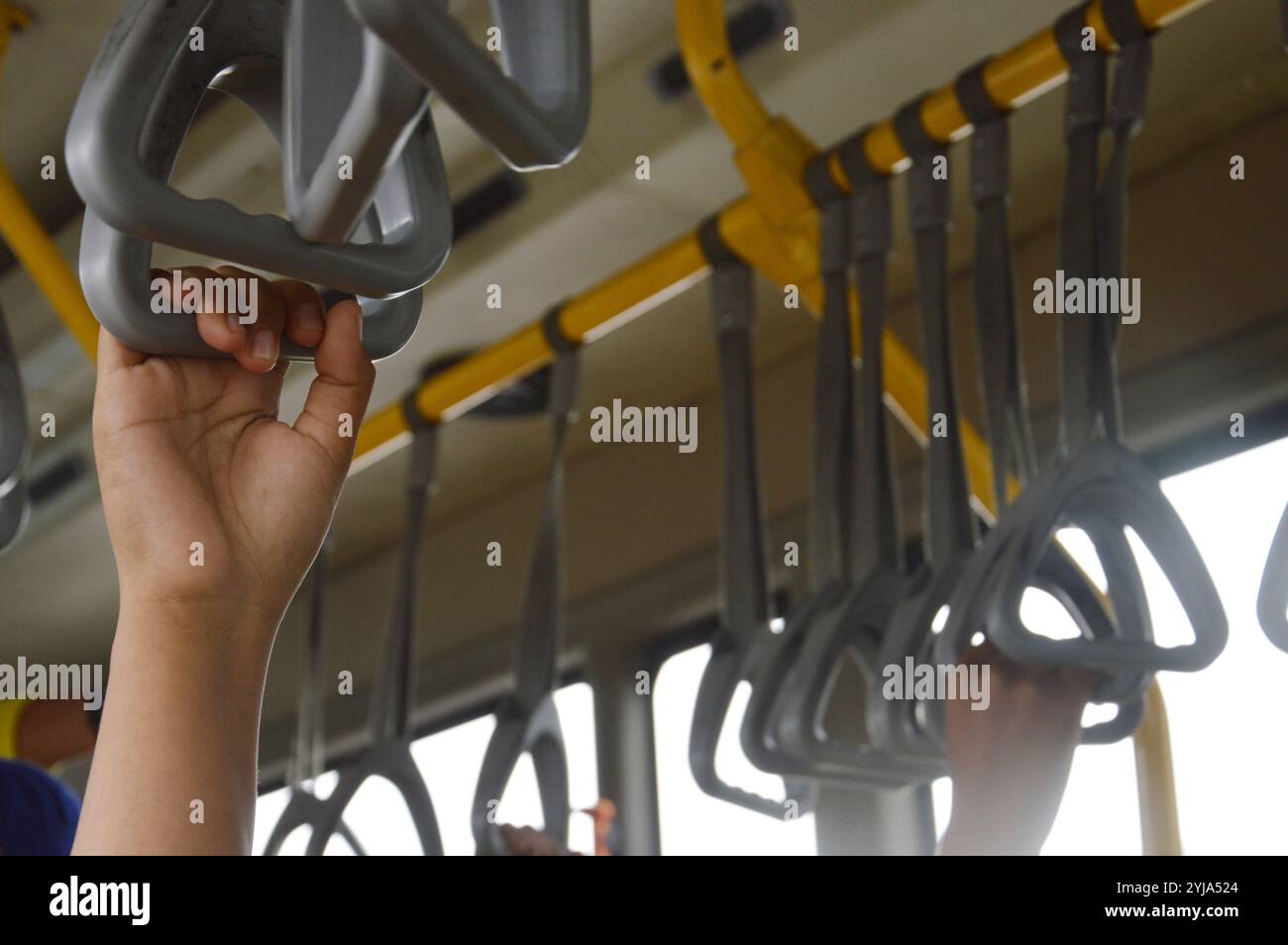 strap hangers on the bus Stock Photo - Alamy