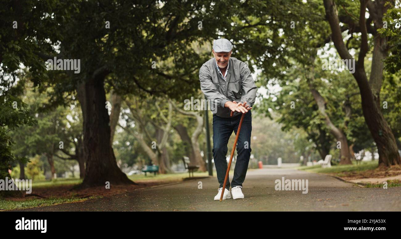 Elderly man, walking stick and dance in park with energy, happiness and ...