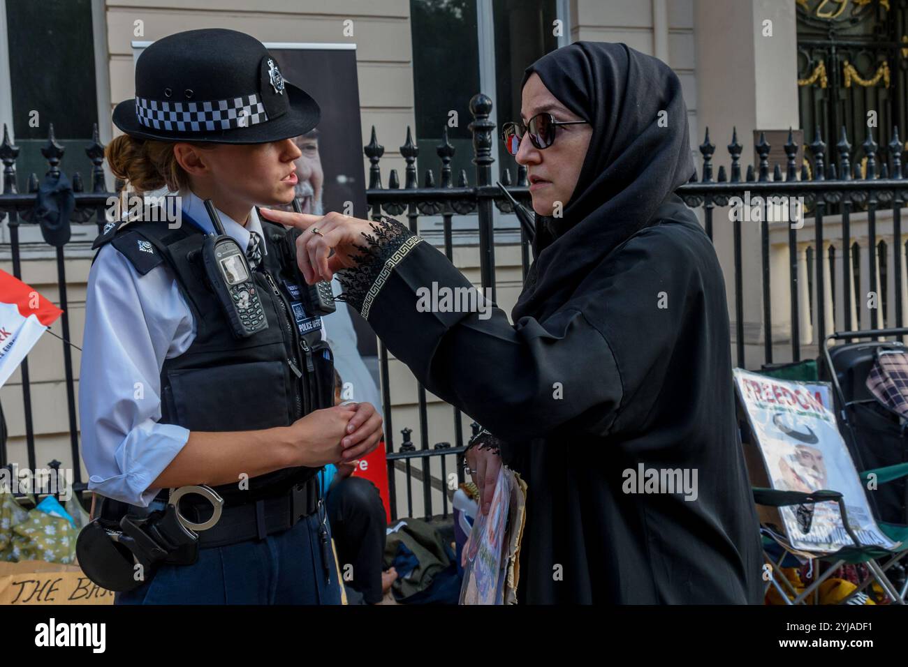 London, UK. 13th August 2018. Protesters argue with police officers who ...