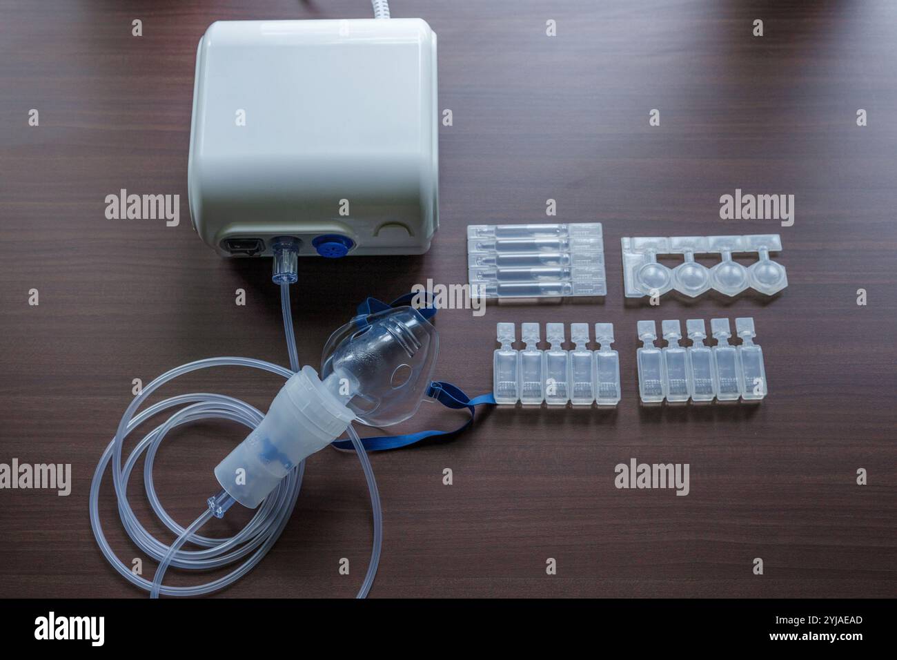 A medical nebulizer machine with attached mask and various ampoules for ...