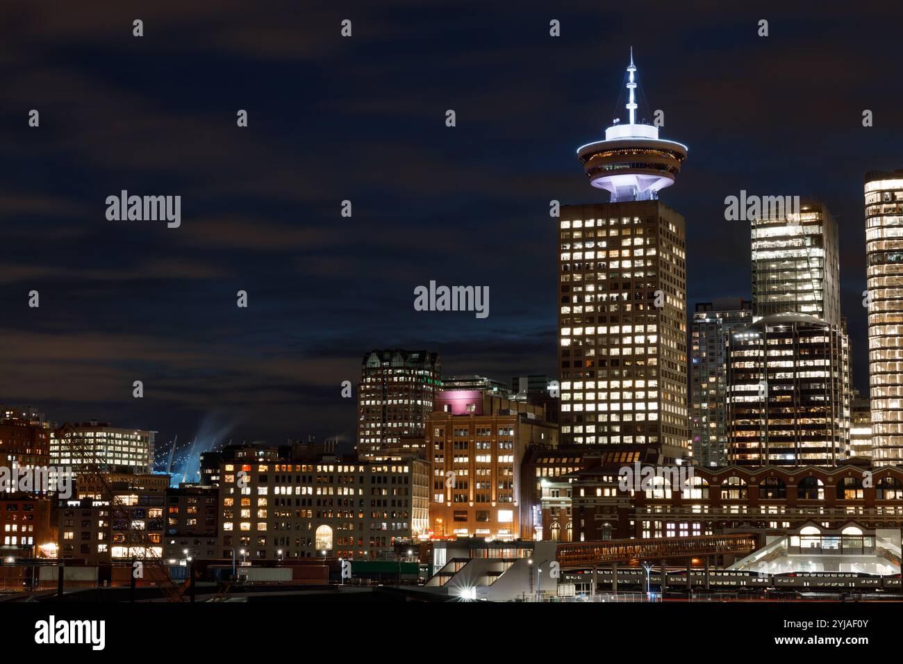 A stunning nighttime view of Vancouver's illuminated skyline ...