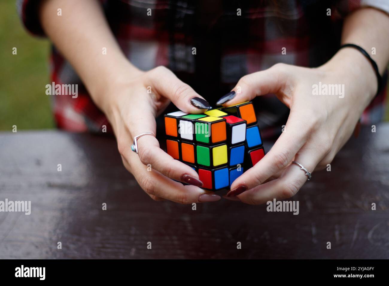 Vancouver, Canada - Oct1,2019: Hands manipulating a colorful Rubik's ...