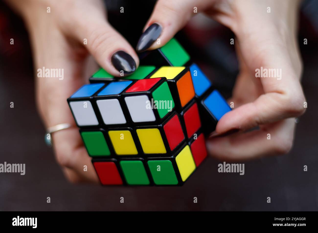 Vancouver, Canada - Oct1,2019: Hands manipulating a colorful Rubik's ...