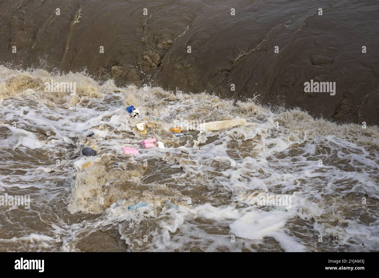 Floating garbage and debris swept by powerful river currents after ...