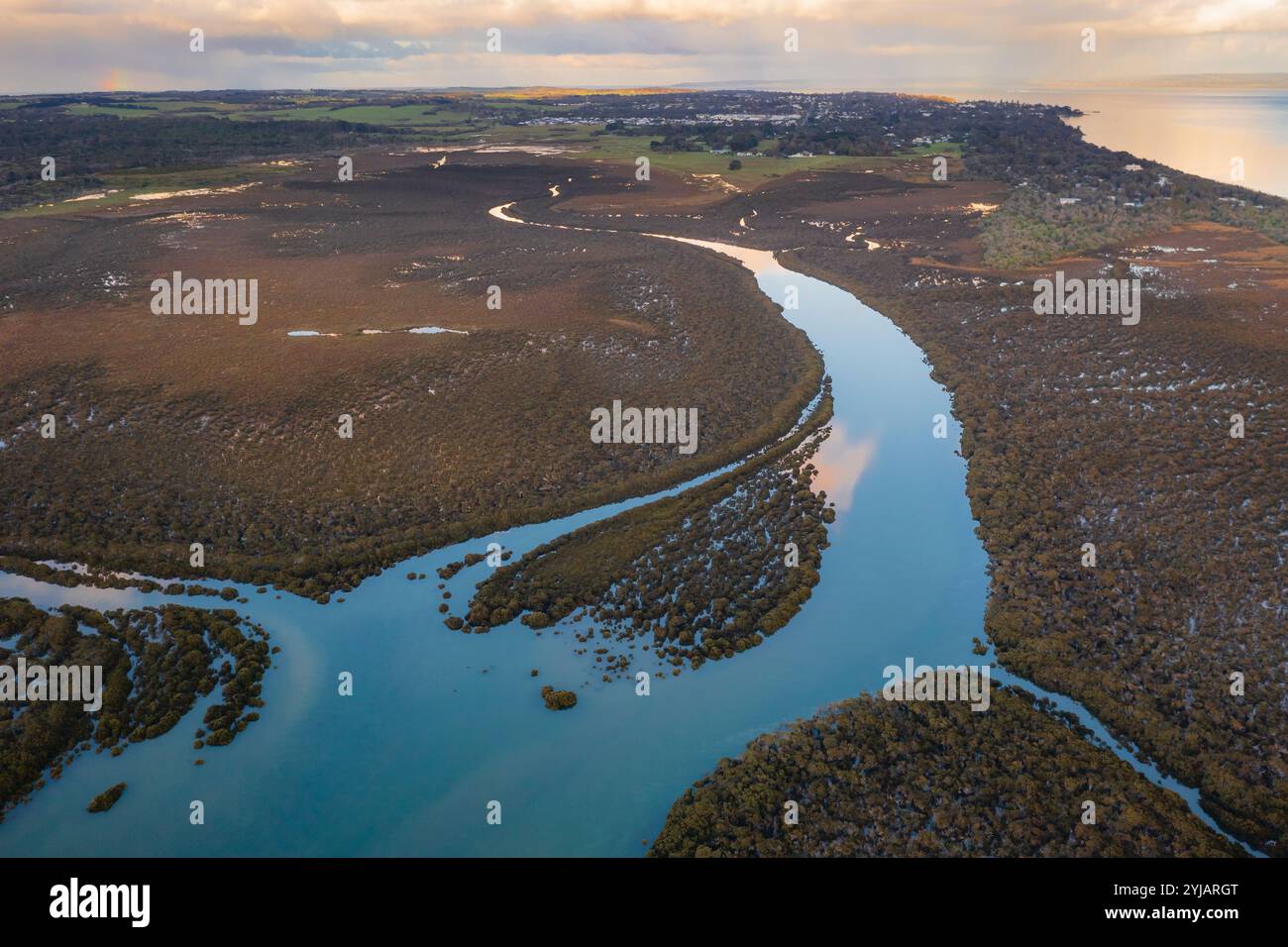 Aerial view of creeks and channels running through a coastal wetland at ...