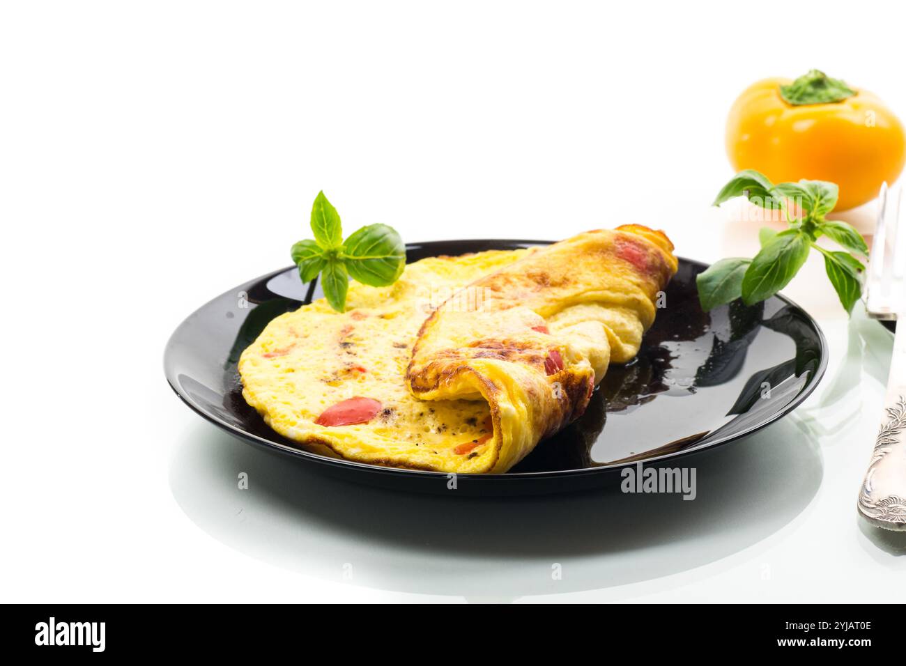 fried omelette with sweet pepper and vegetables in a plate, isolated on ...