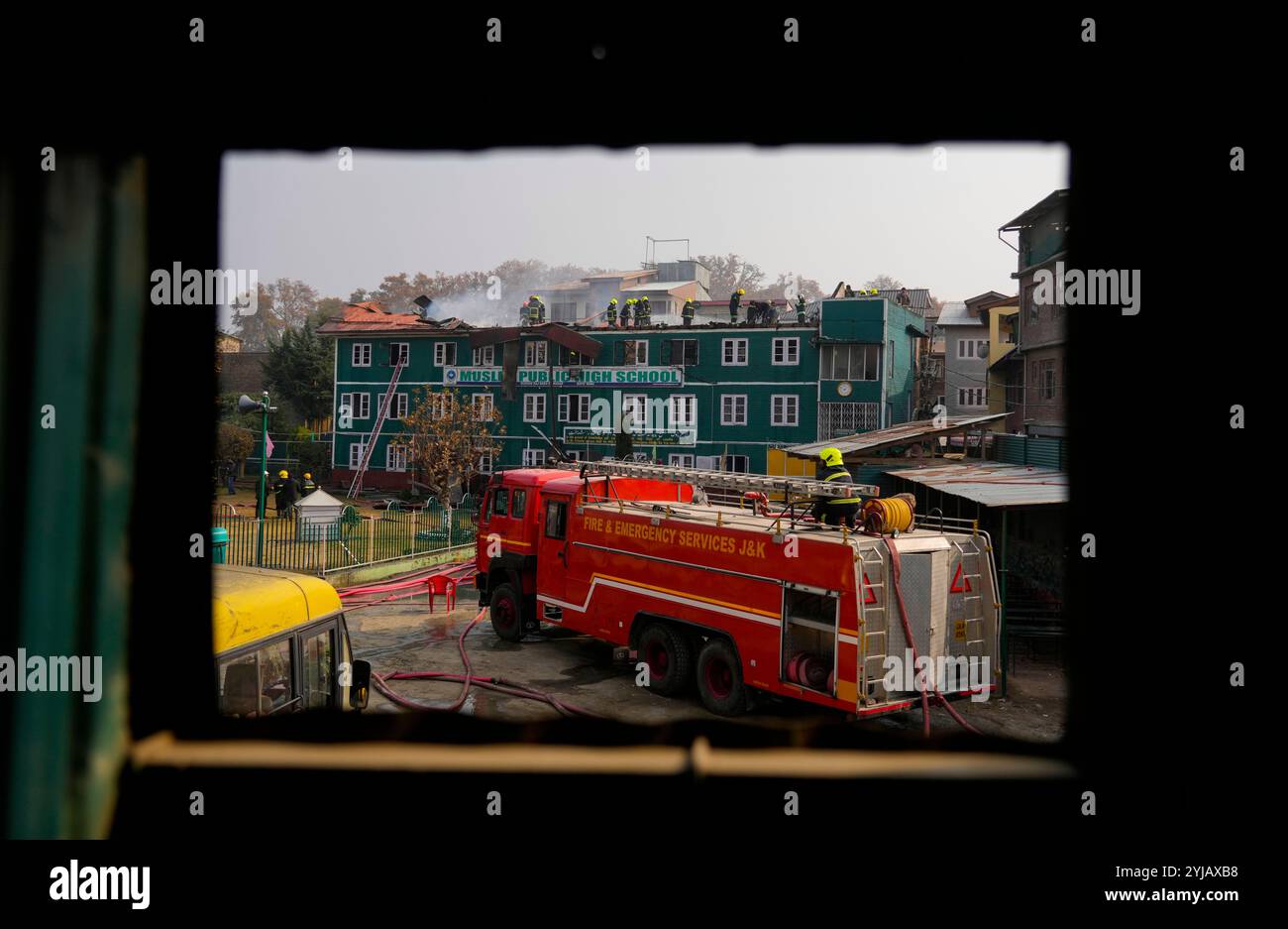 Indian firefighters work to extinguish a fire on a school building in ...