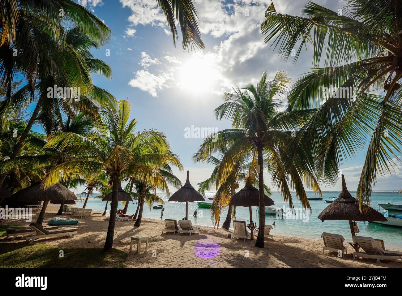A photograph capturing a coastal scene in Mauritius, featuring a sandy ...