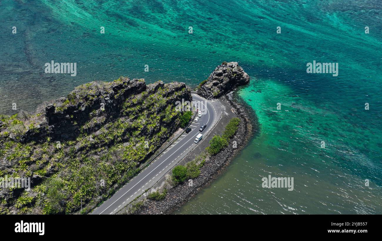 This aerial photo captures a car driving on a road alongside a ...