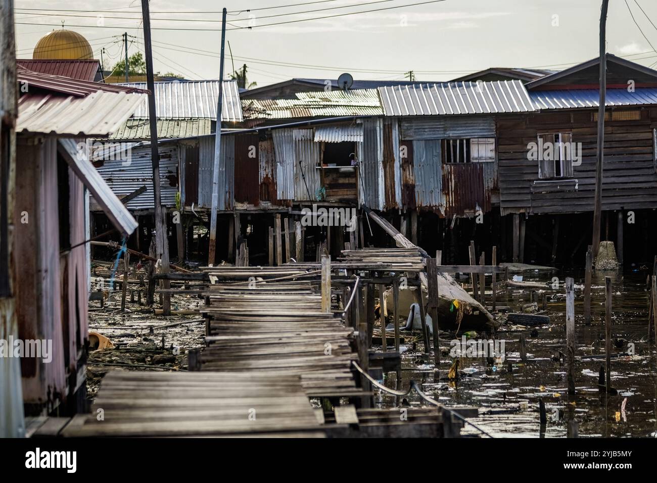 Fishing village houses over the water garbage poor areas in Sabah ...