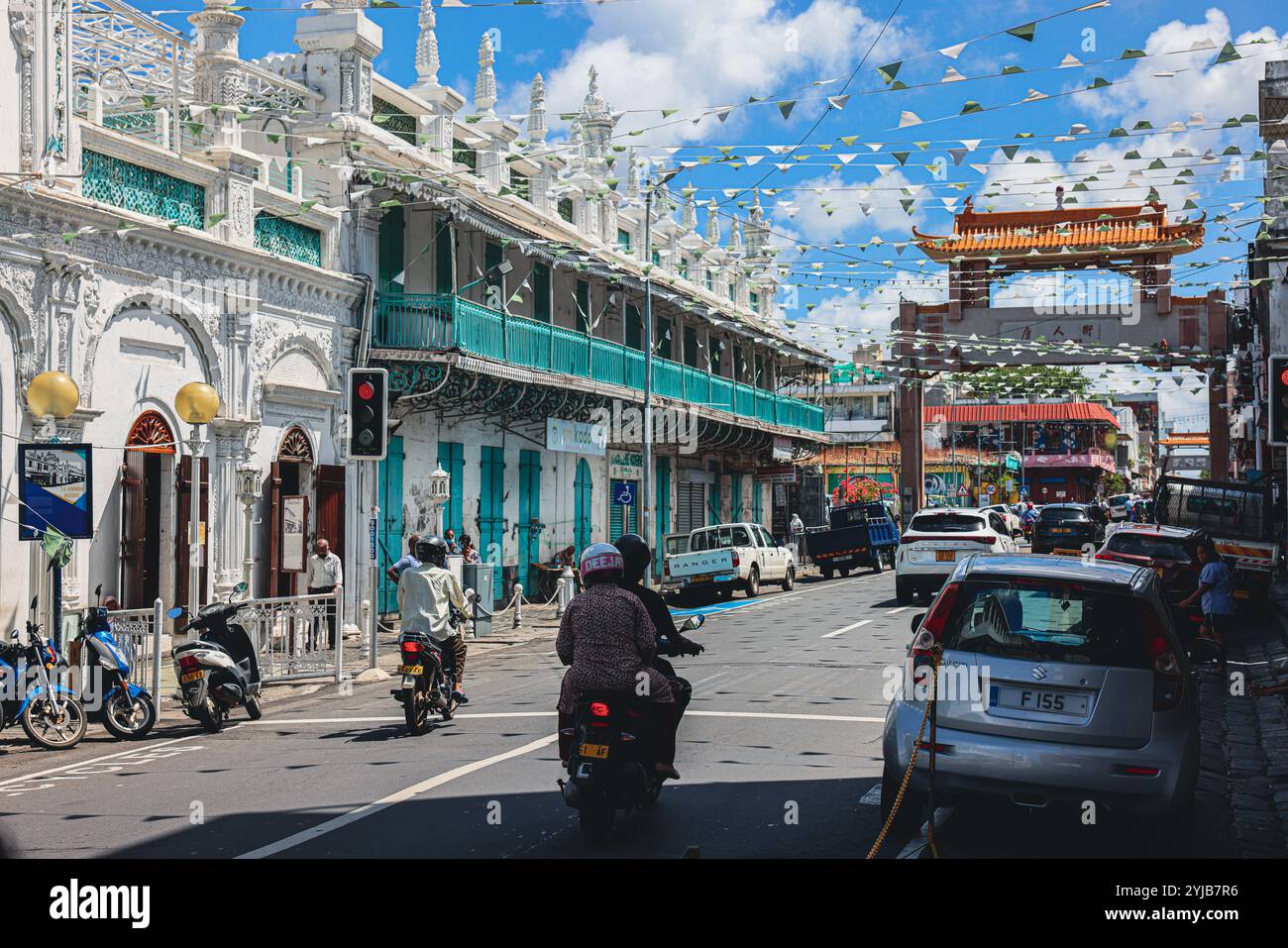 A vibrant city street in Port Louis, Mauritius, teeming with cars and ...