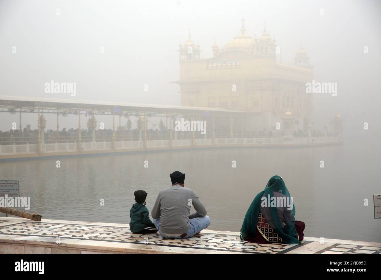 Smog at the Golden Temple, in Amritsar, India Devotees sit near the ...
