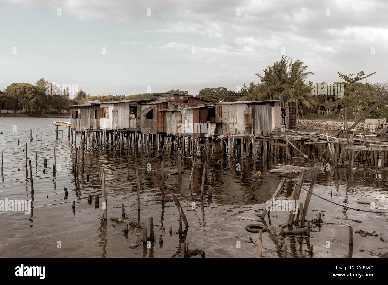 Fishing village houses over the water garbage poor areas in Sabah ...