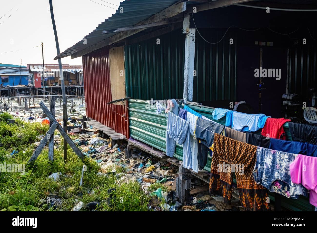 Fishing village houses over the water garbage poor areas in Sabah ...