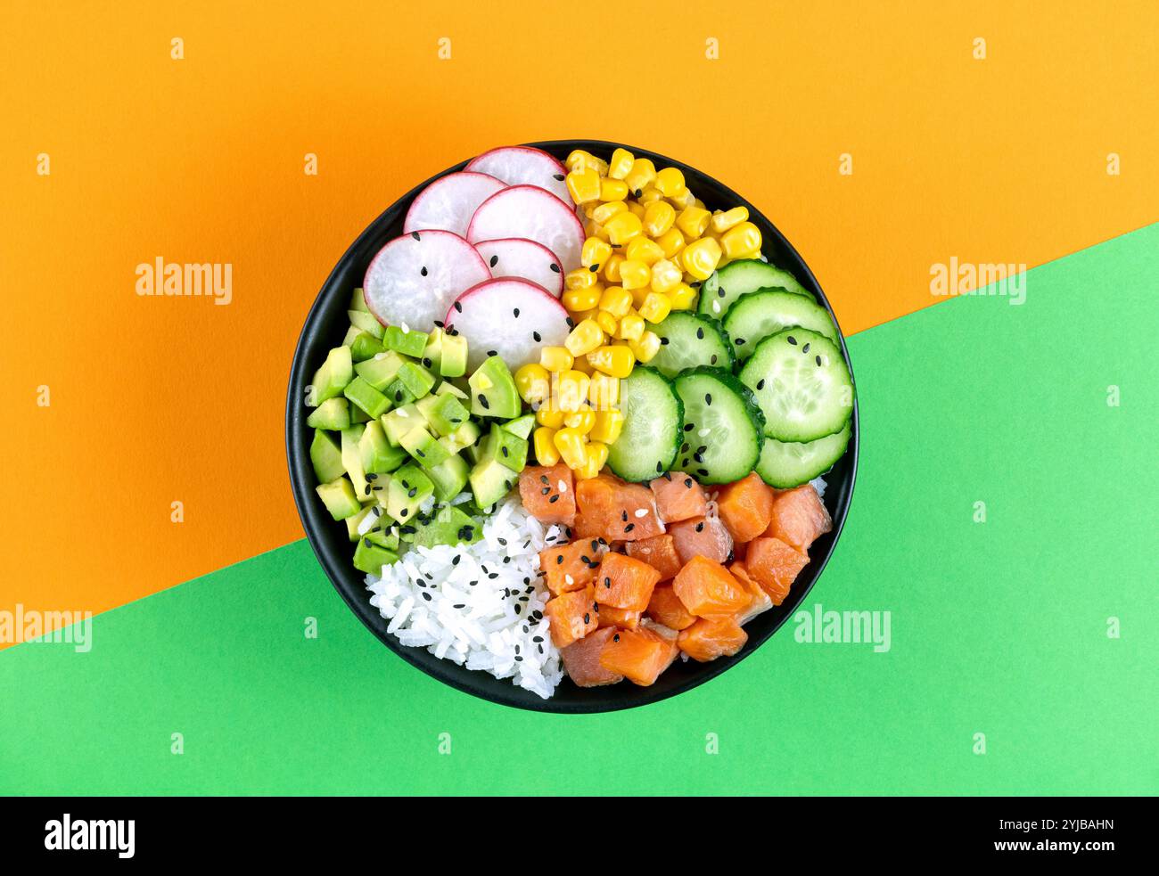 Poke bowl with salmon, rice, cucumber, corn, radish, avocado on a ...