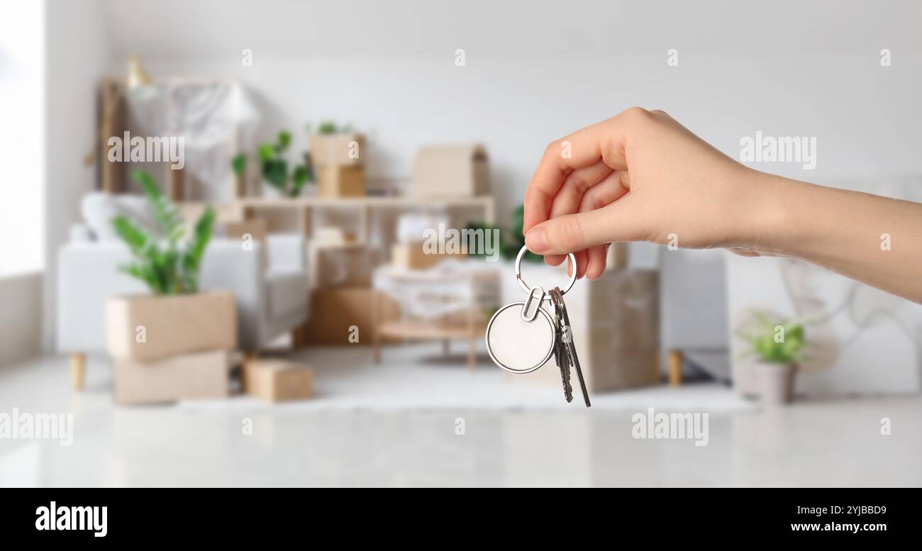 Female hand holding keys from new house in room on moving day Stock ...