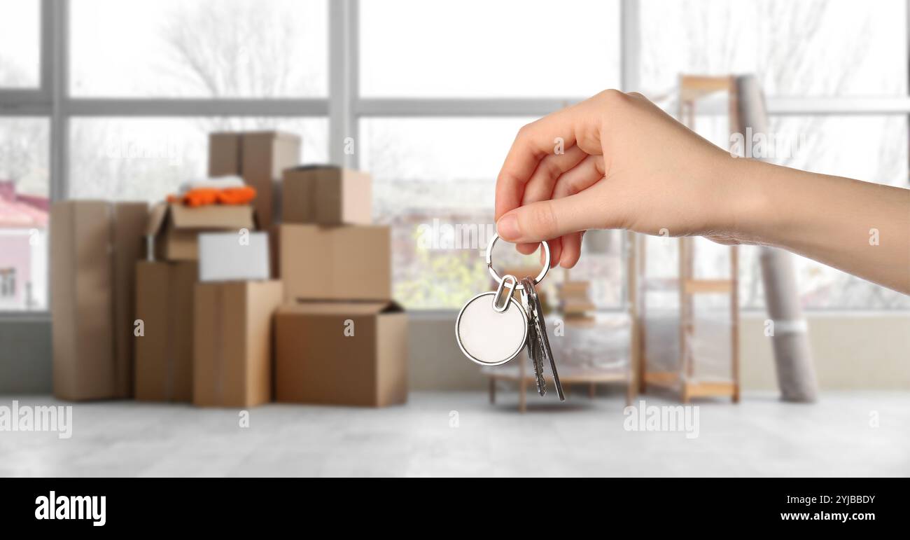 Female hand holding keys from new house in room on moving day Stock ...