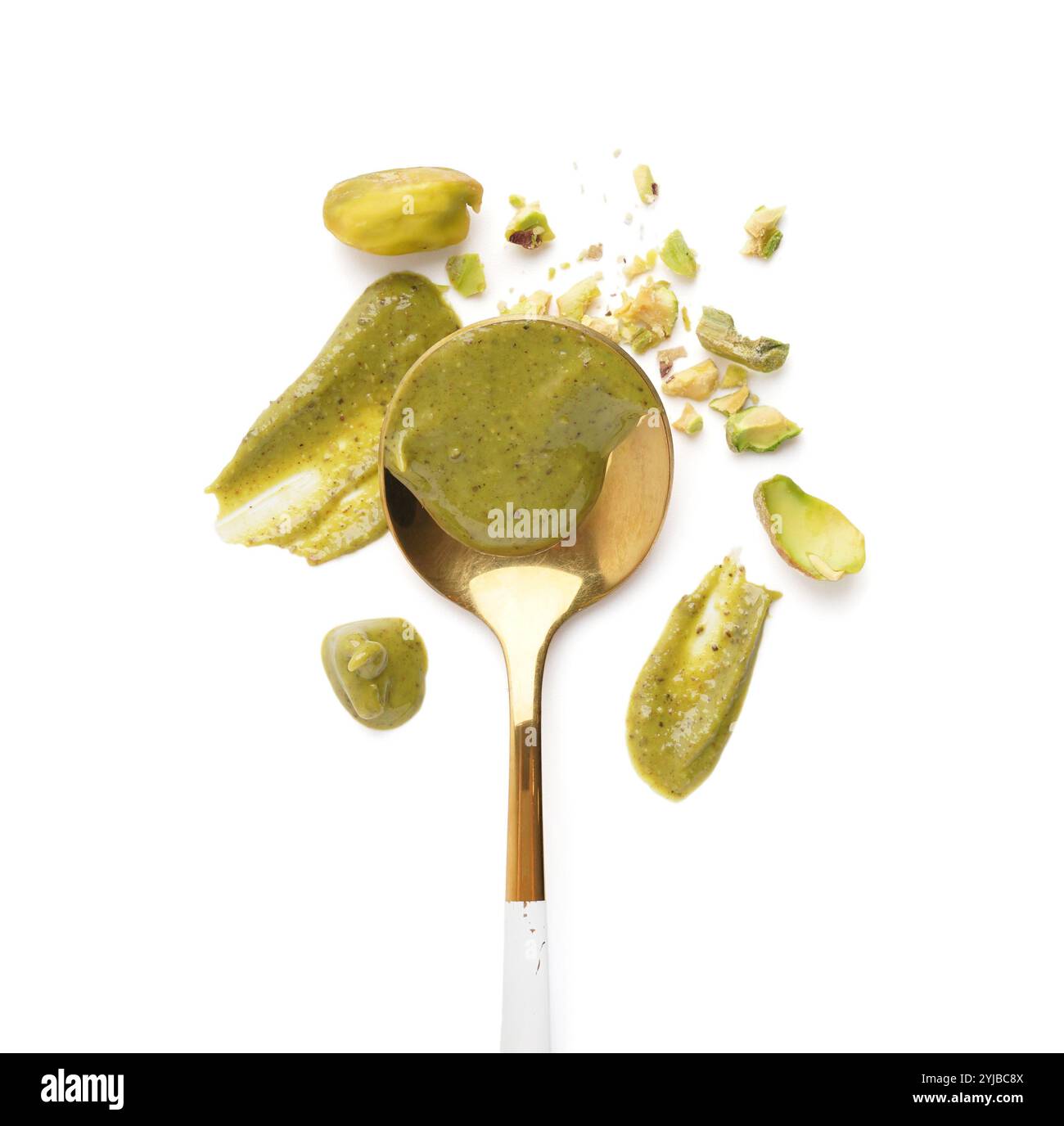 Spoon with tasty pistachio paste on white background Stock Photo - Alamy