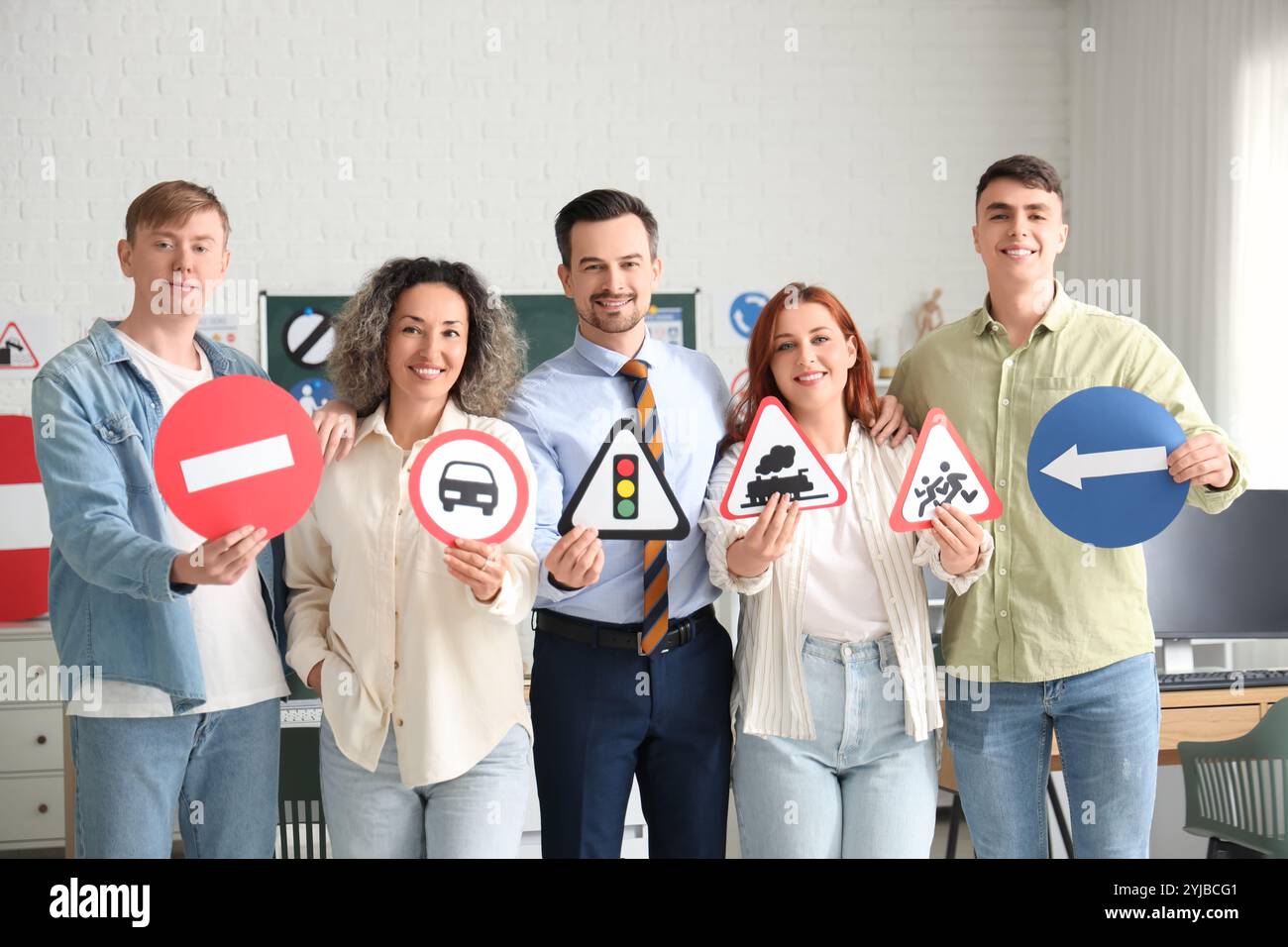 People with instructor and road signs at driving school Stock Photo - Alamy