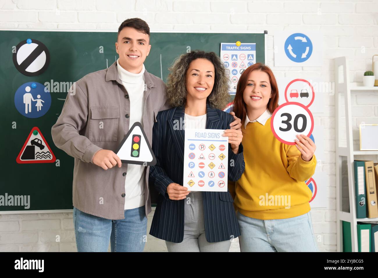 People with instructor and road signs at driving school Stock Photo - Alamy