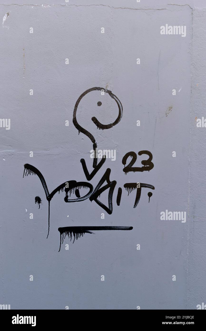 A tag daubed in black paint on a grey painted wall in Newquay in ...
