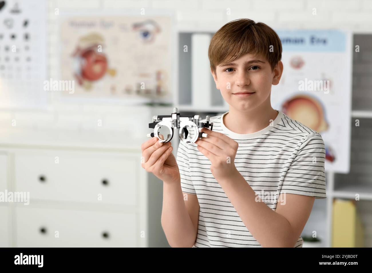 Little boy with optical trial eye frame in clinic Stock Photo - Alamy
