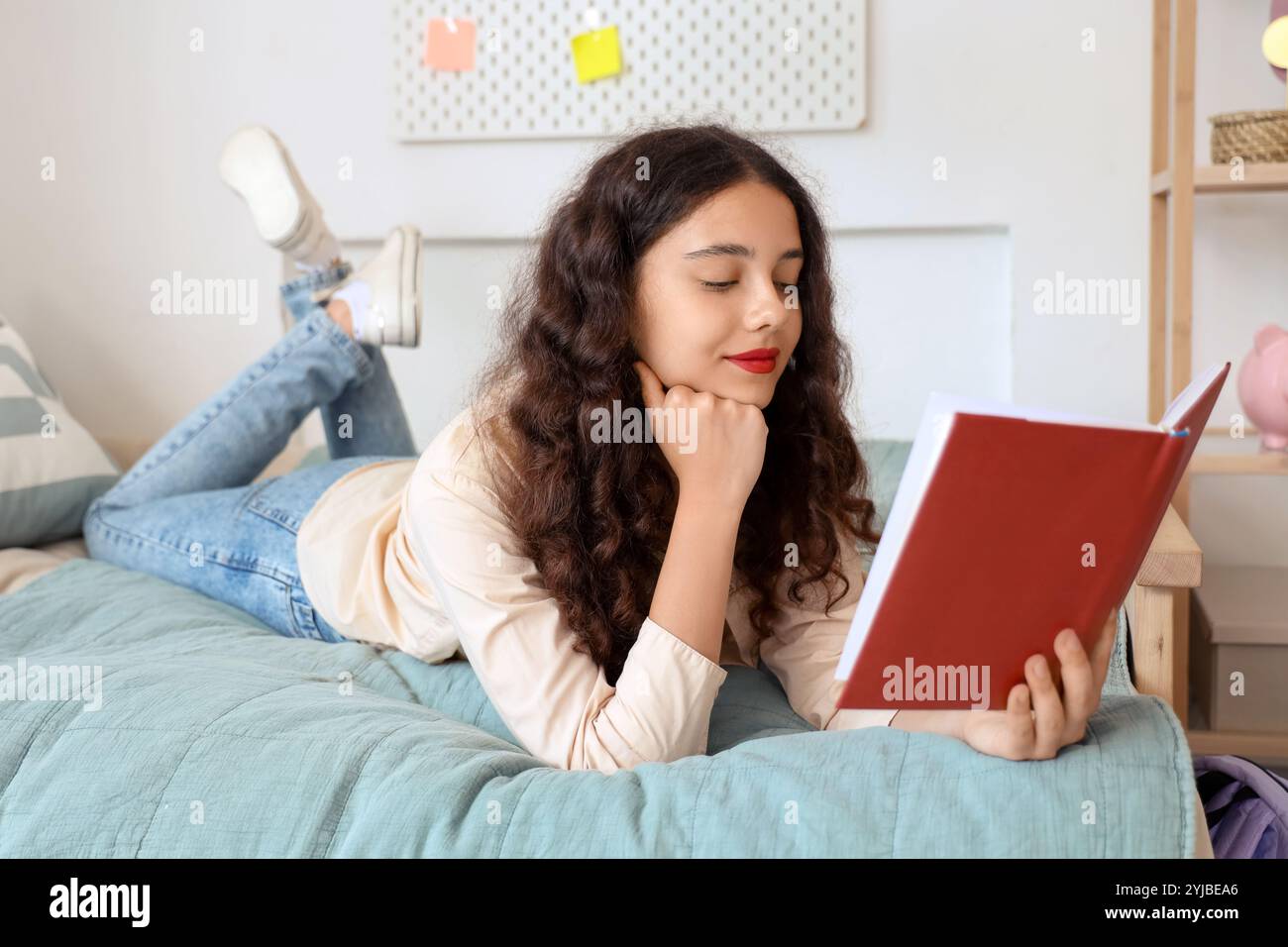 Teenage girl reading book in bedroom Stock Photo - Alamy