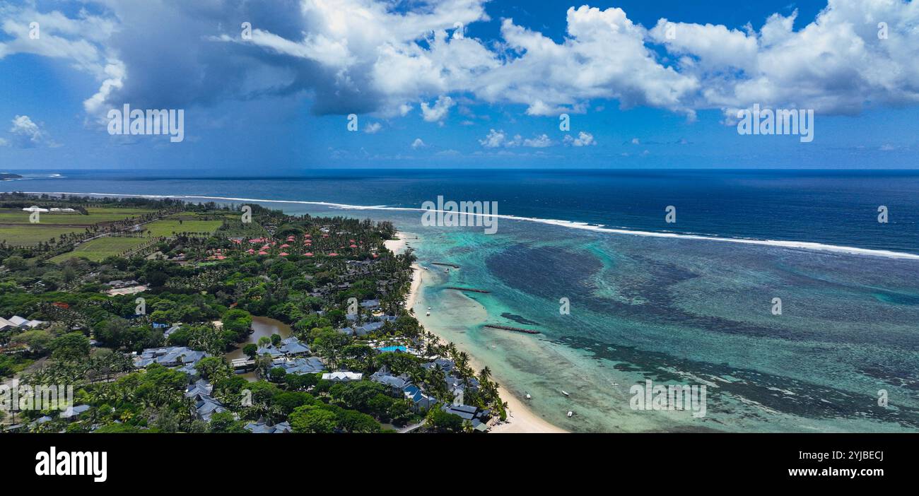 This photo captures an aerial view of a beach and ocean in Mauritius ...