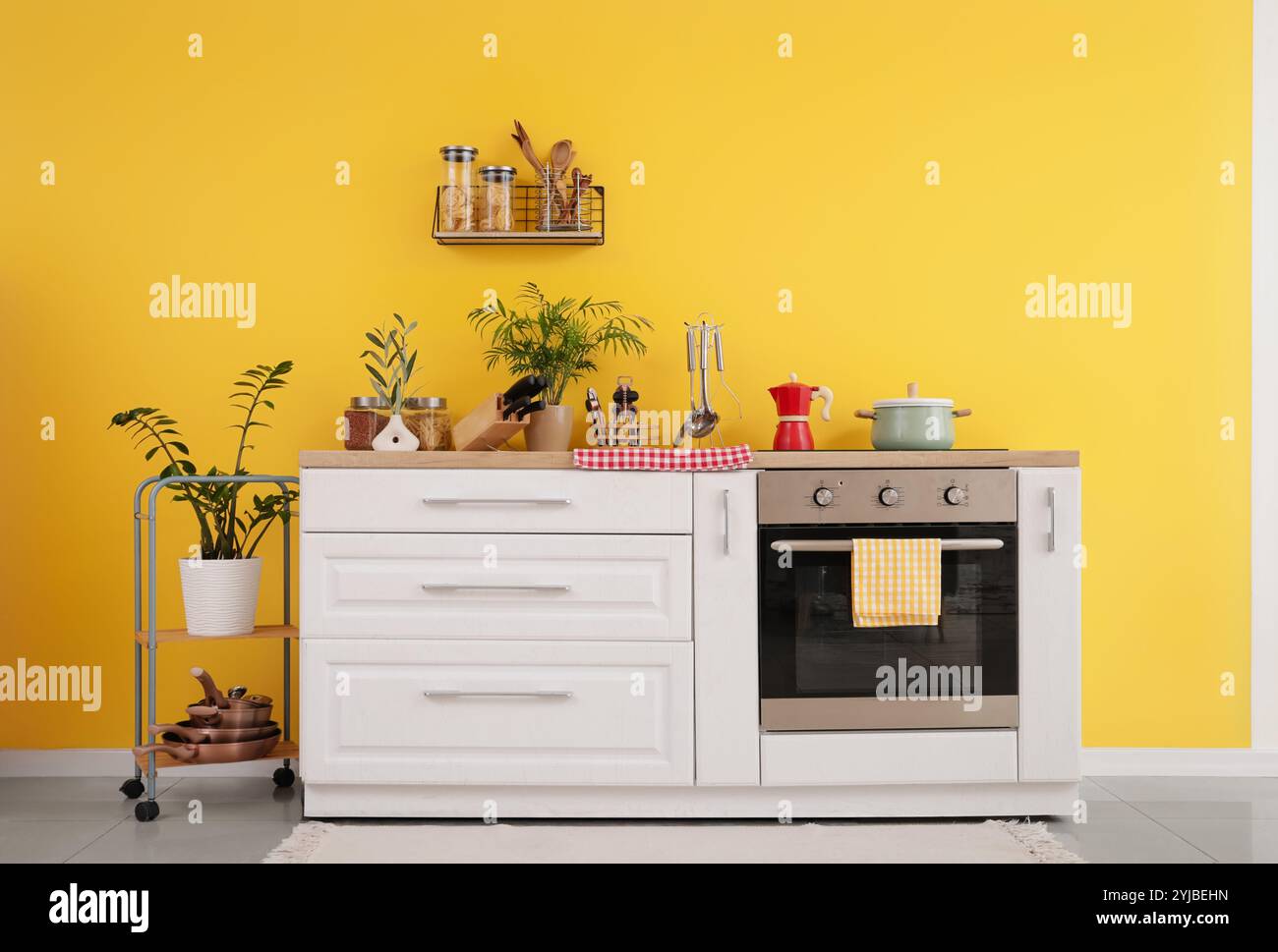 Interior of kitchen with counter, oven and utensils Stock Photo - Alamy