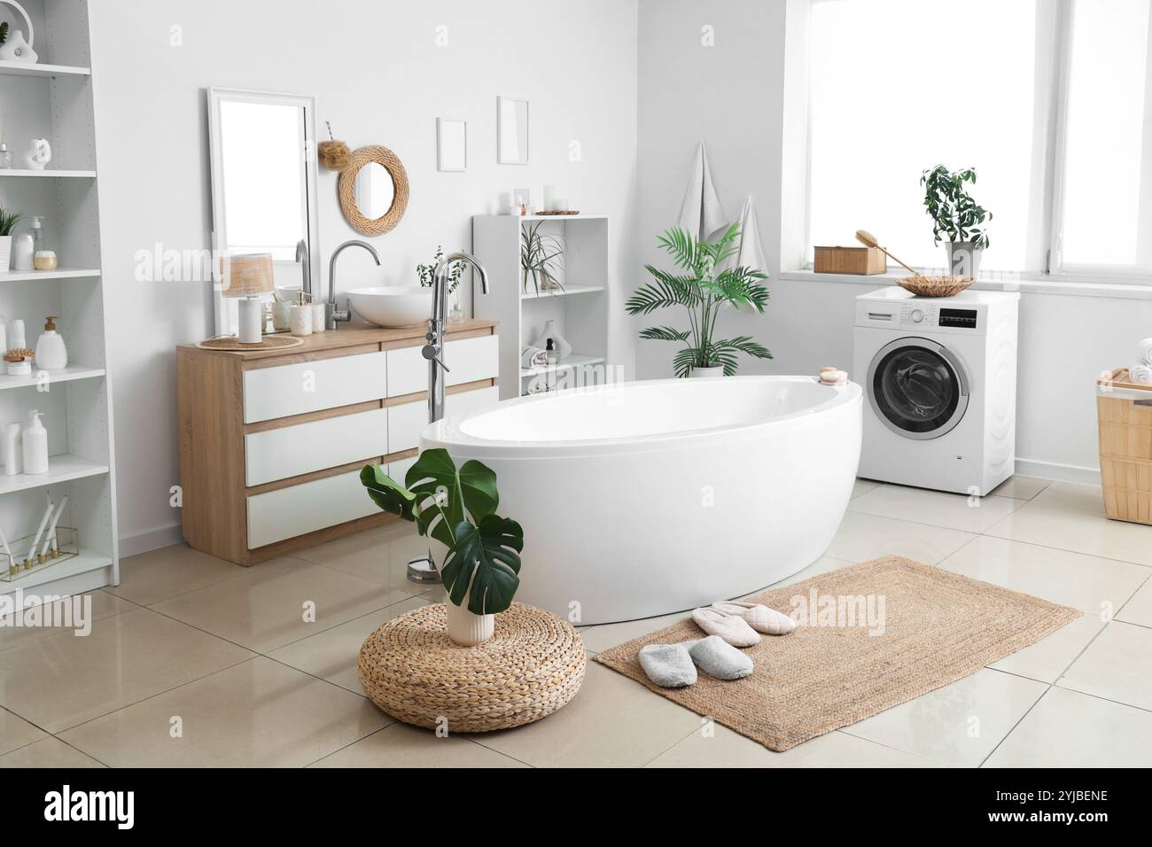 Interior of bathroom with bathtub, washing machine and wicker mat Stock ...