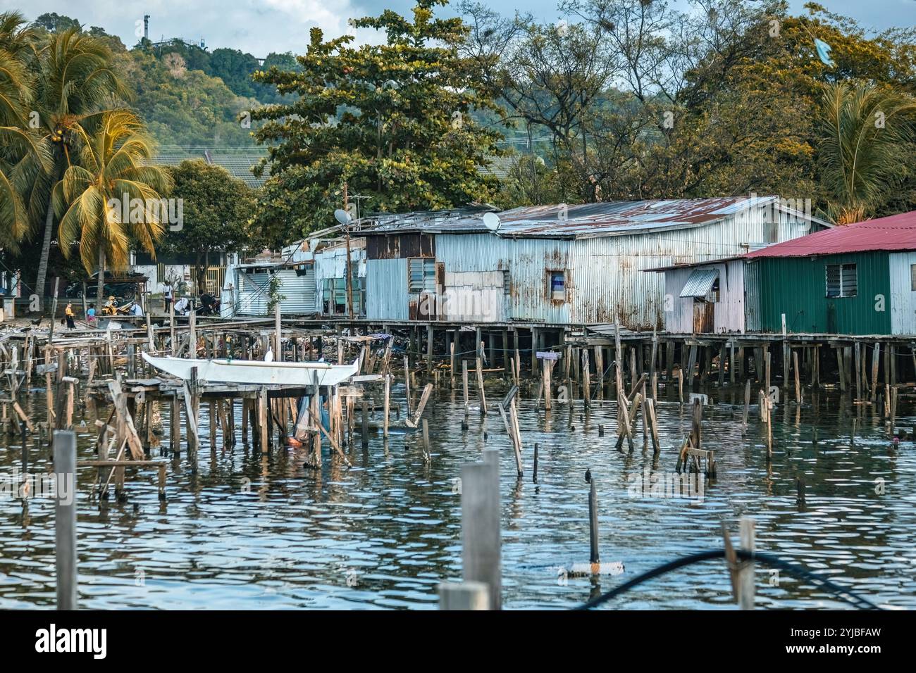 Fishing village houses over the water garbage poor areas in Sabah ...