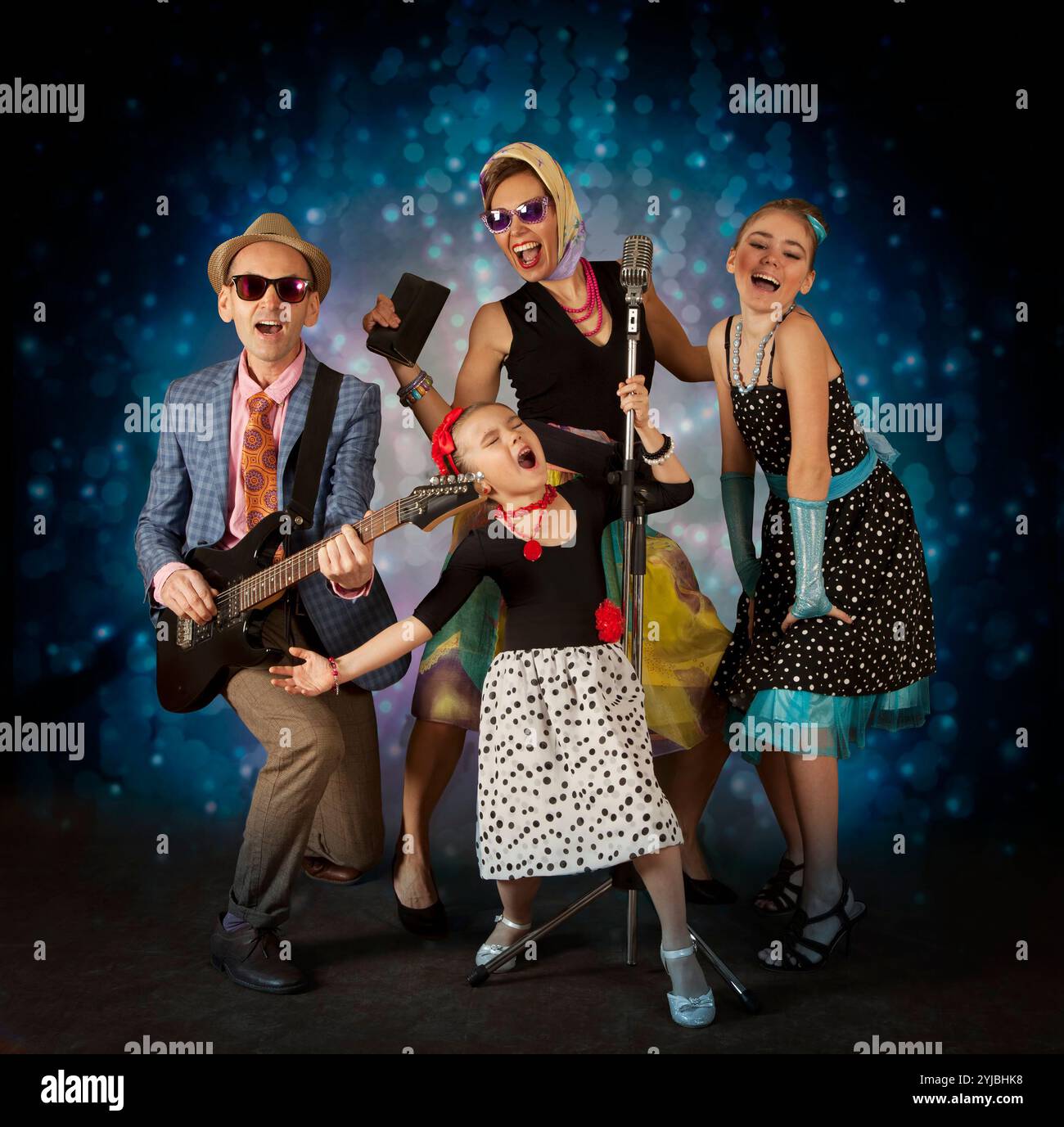 Rockabilly family band having fun playing music and posing with vintage ...