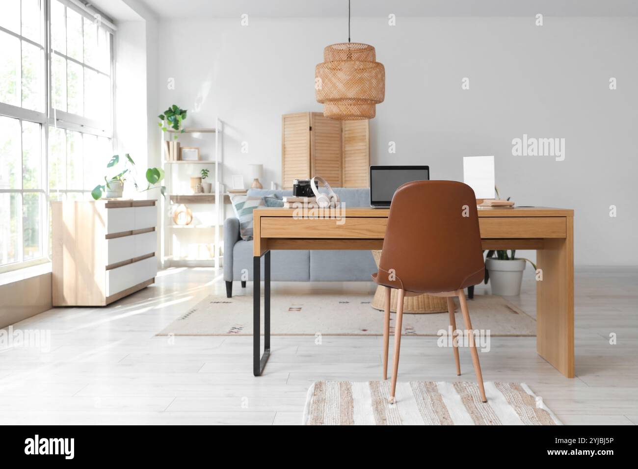 Interior of light living room with programmer's workplace, drawers and ...