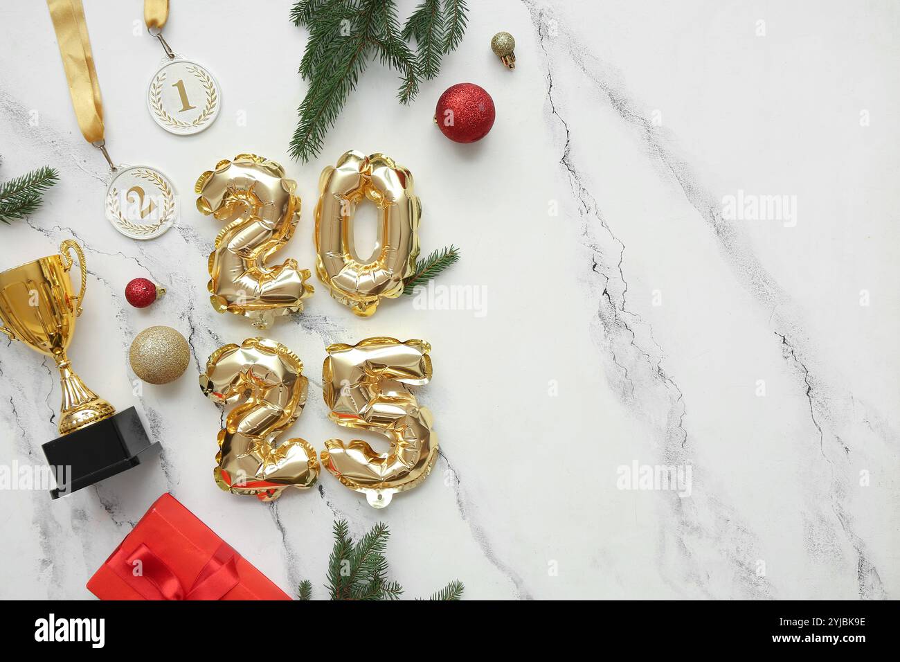 Figure 2025 with gold cup, prize medals and Christmas decor on white ...