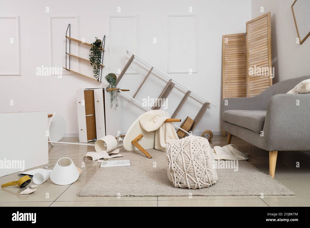 Interior of messy living room with overturned furniture after ...