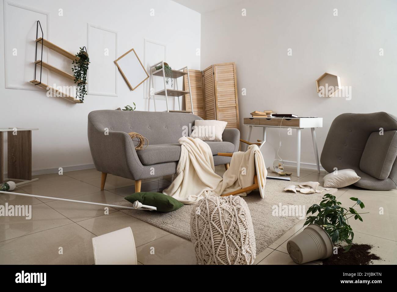 Interior of messy living room with overturned furniture after ...