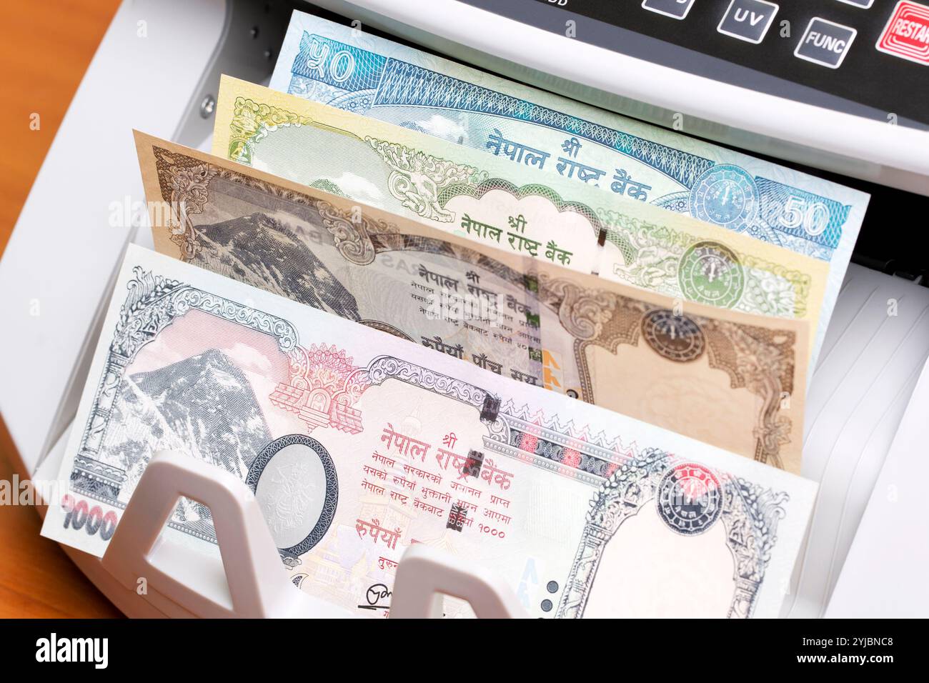 Nepalese money - rupee in the counting machine Stock Photo - Alamy