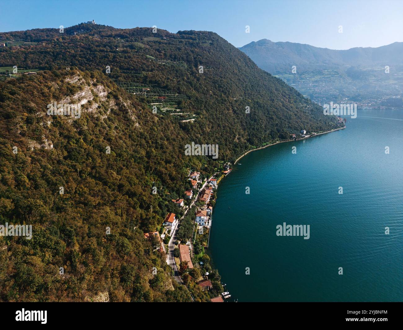 Aerial view of a scenic lakeside village nestled along the base of ...