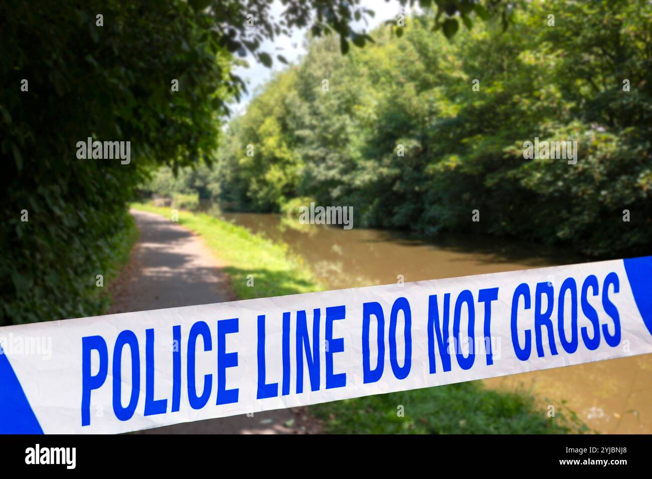 Blue and white police line do not cross crime scene tape in focus with ...
