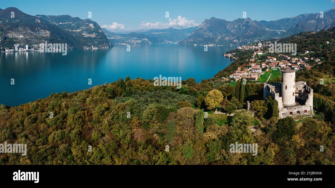 Aerial view of a historic stone tower on a lush hillside overlooking a ...