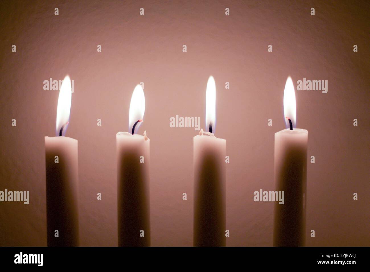 four simple lighted candles Stock Photo - Alamy
