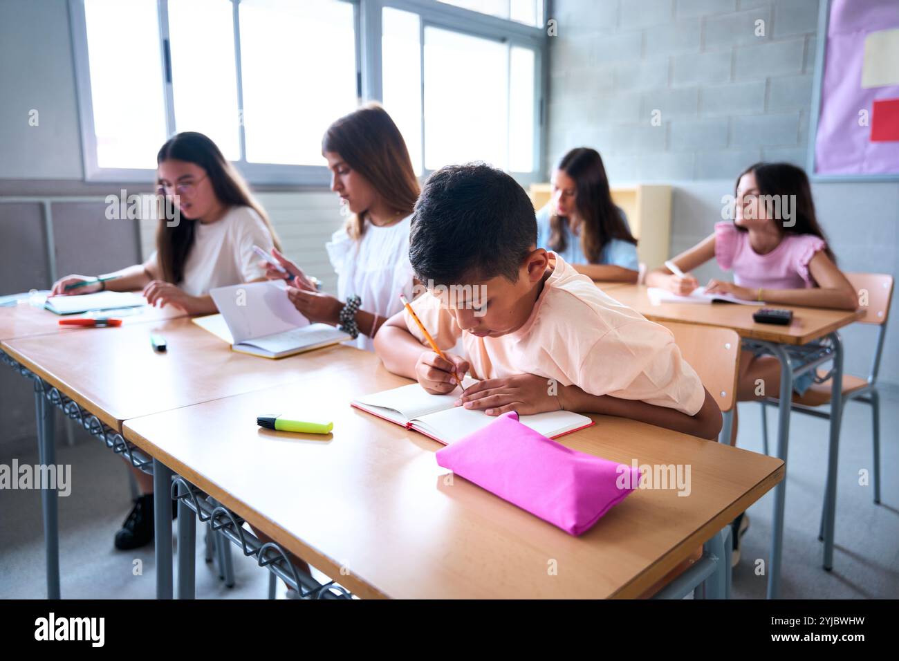 Latin boy elementary school student concentrated doing teacher lesson ...