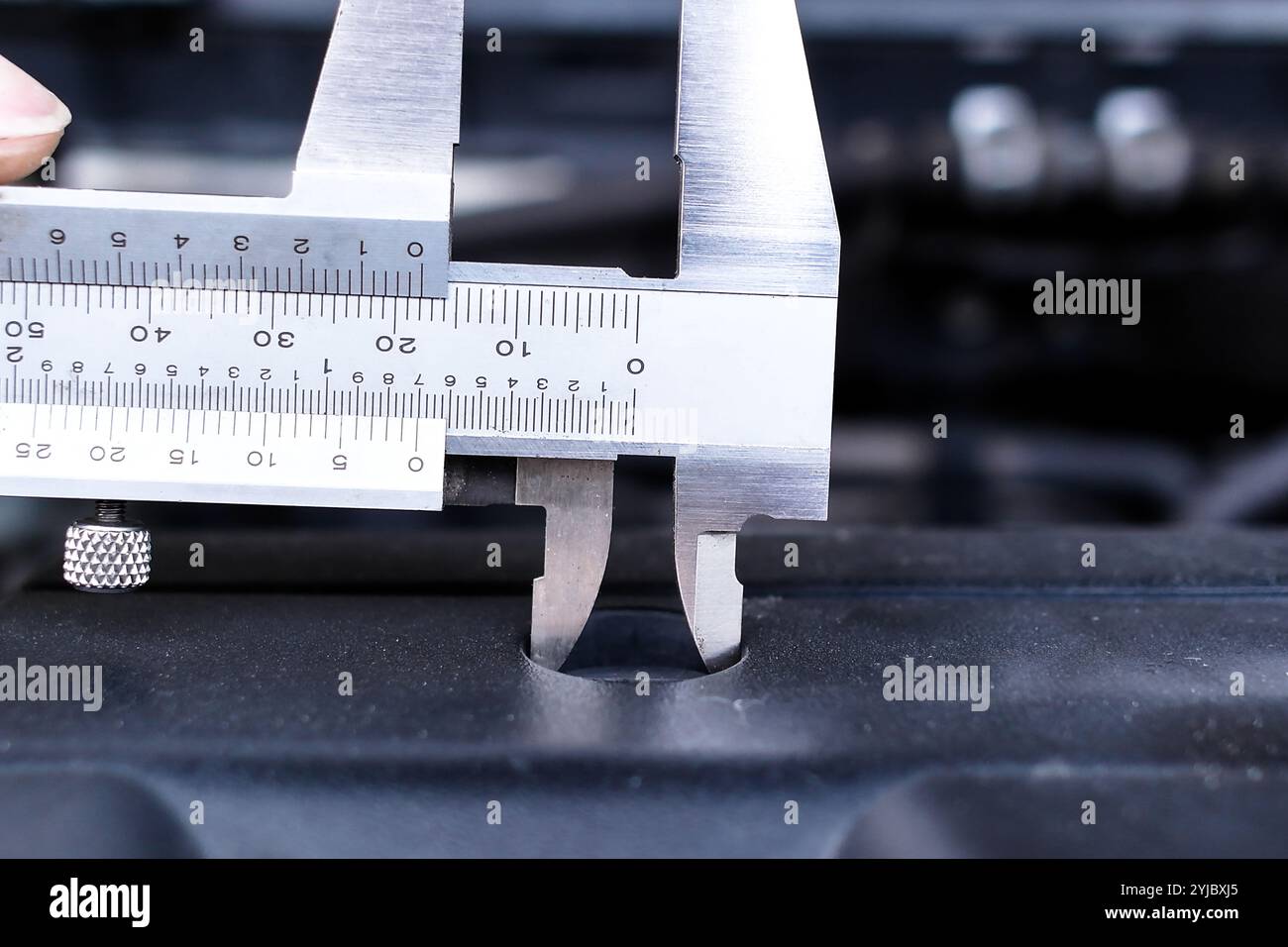 Close up of vernier caliper measuring engine component , Mechanics tool ...