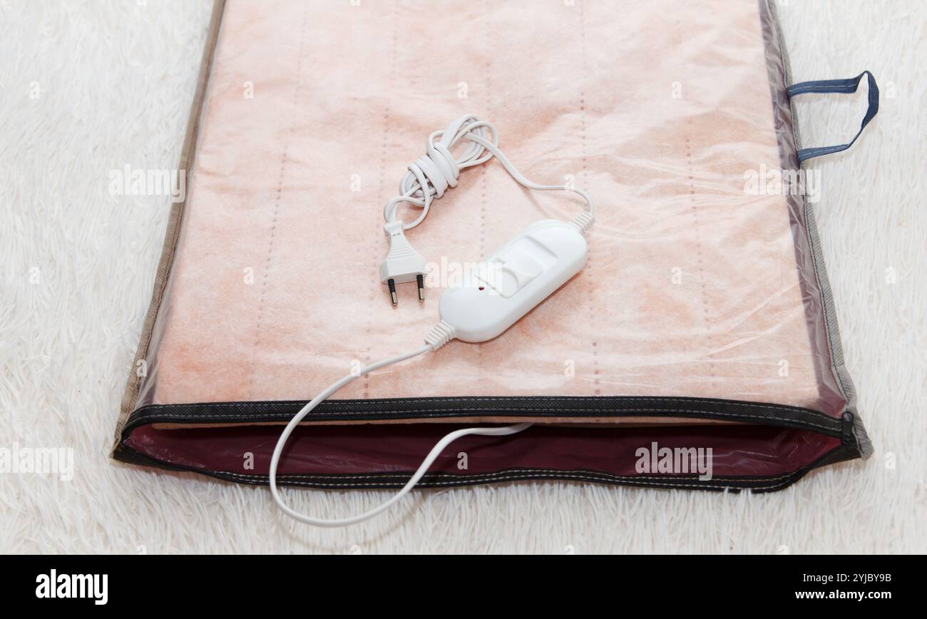 A warm two-sided new electric sheet, lies assembled, and on top of the ...