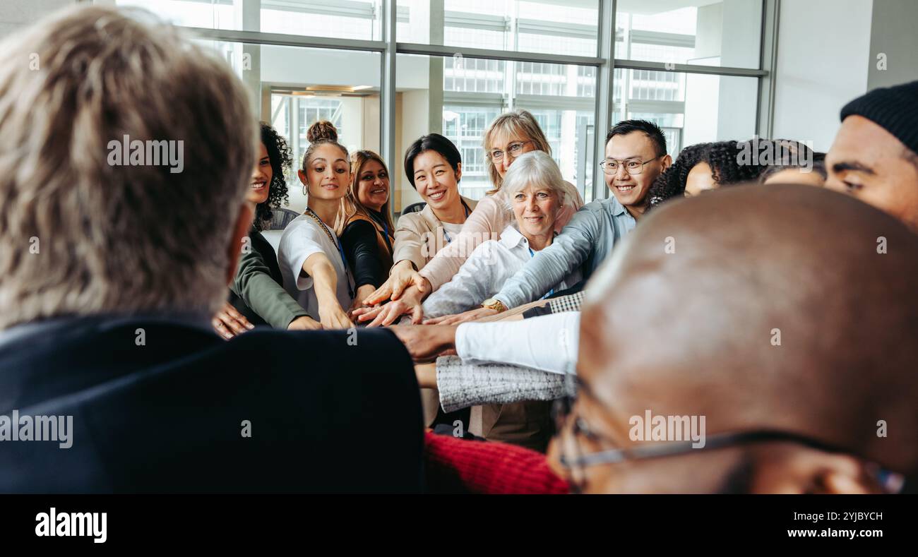 A diverse group of professionals working together, showing team spirit ...