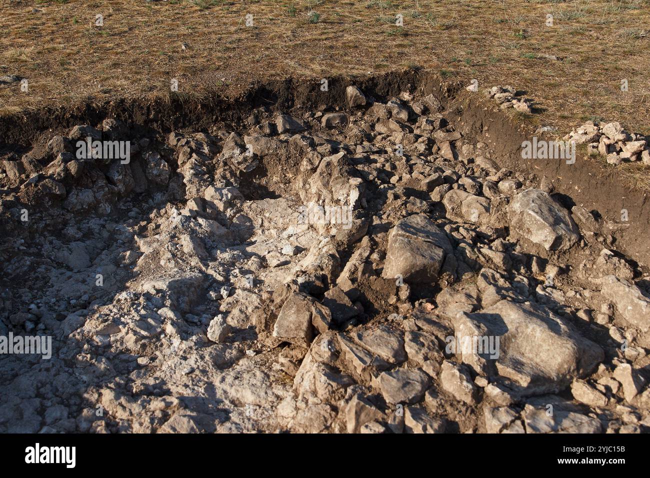 Archeologists' place of work. Rocky bottom of an archaeological pit dug ...