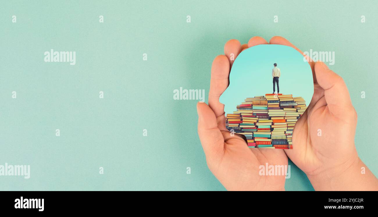 Man is standing on pile of books, reading and learning new skill ...